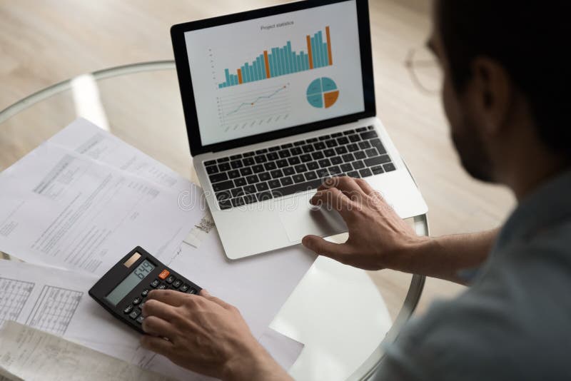 Closeup Man Verifies Data Financial Reports with Graphs on Computer ...