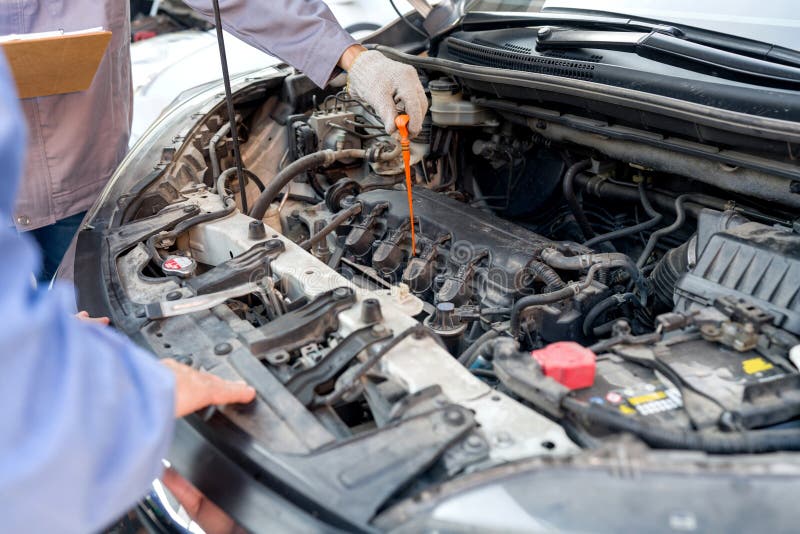 Closeup Mechanic Hand with Protective Glove Checking the Oil Level of a ...