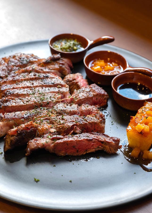 Closeup Medium Rare Ribeye Steak on Wood Table Stock Image - Image of ...