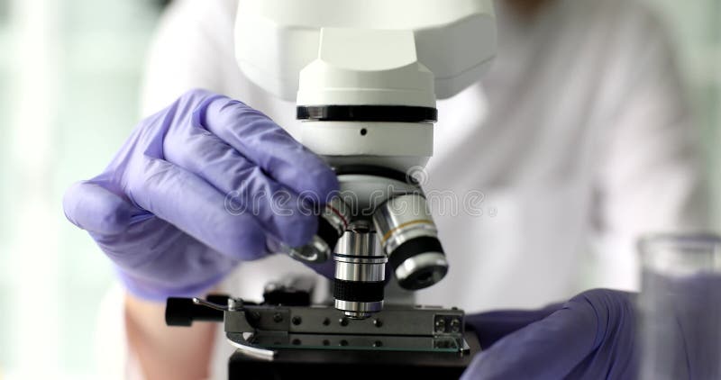 Closeup of Microscope and Scientist Hand with Microscope in Laboratory ...