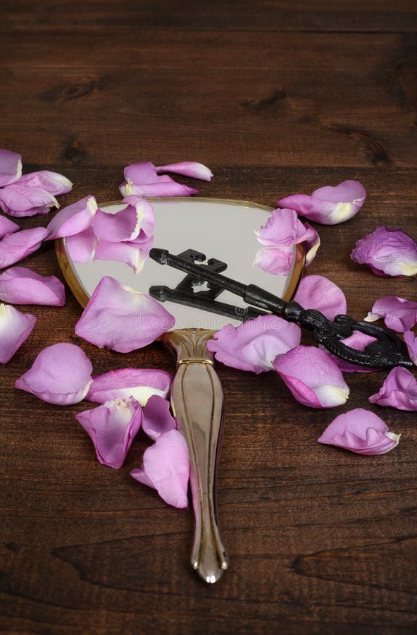 Closeup Mirror with Pink Rose Petals and a Key Stock Photo - Image of ...