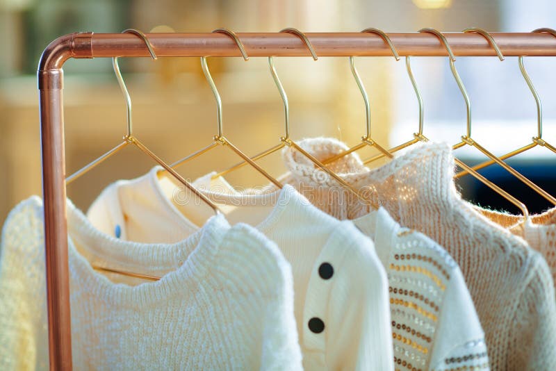 Closeup on Modern Copper Clothes Rack with Sweaters on Hangers Stock ...