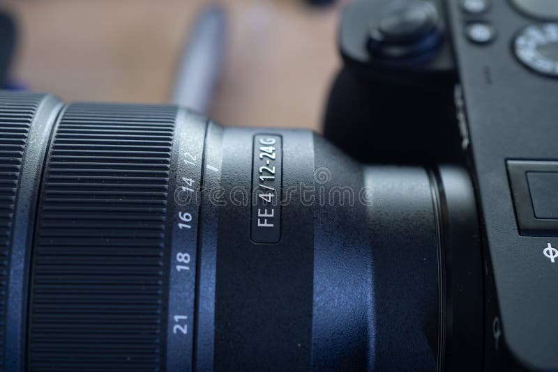 Closeup of a Modern DSLR Camera Under the Lights with a Blurry ...