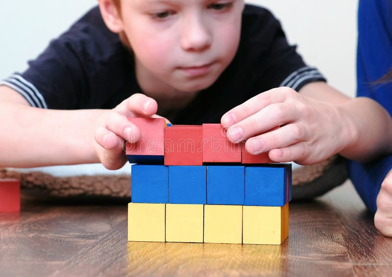 Closeup Mom and Son`s Hands Building a Boxes from Colored Cubes and ...