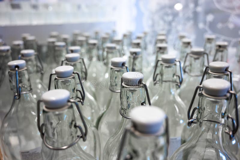A Closeup of the Neck of a Bottle. Group of Empty Bottles with Plastic ...