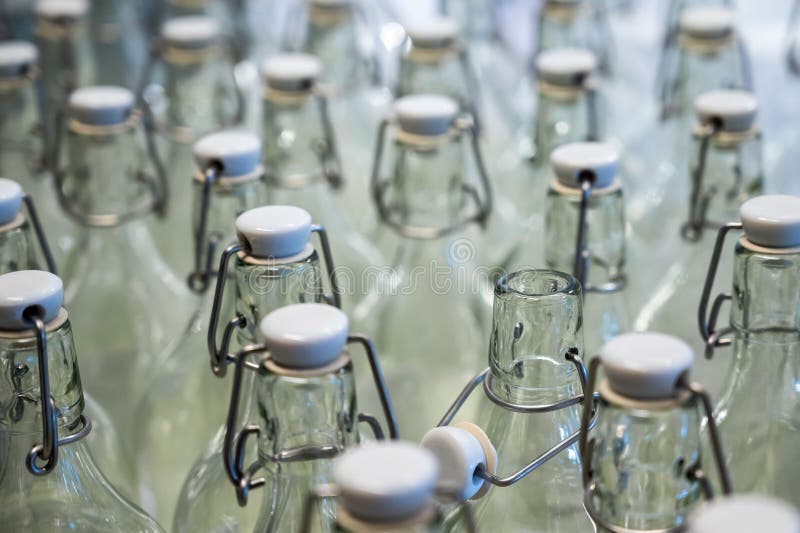 A Closeup of the Neck of a Bottle. Group of Empty Bottles with Plastic ...