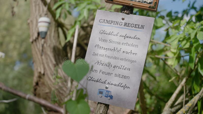 Closeup of a Note of Camping Rules in German Hanging on a Tree with ...