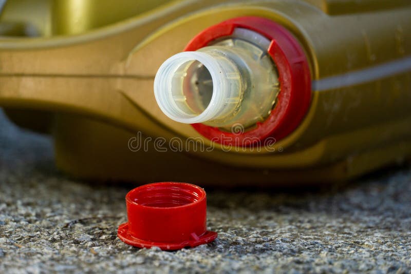 Closeup of an Oil Container with a Red Lid on an Asphalt Stock Image ...