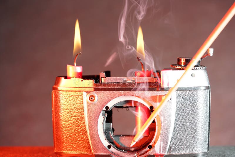 Closeup of an Old Broken Camera with Burnt-out Candles on it Against a ...