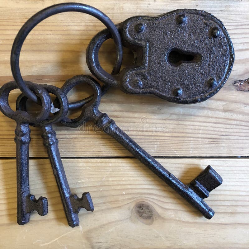 Closeup of an Old Lock with Keys on the Wooden Table Under the Lights ...