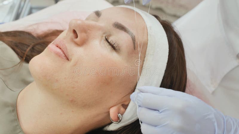 Closeup Part of Face Depilation of Eyebrows with a Thread. Permanent ...