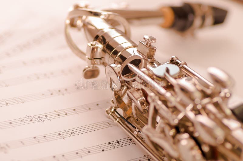 Closeup Partly View of Shiny Saxophone Lying on Musical Notes Paper ...