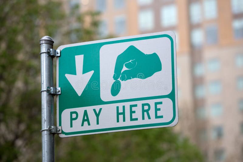 Closeup of a "Pay Here" Sign in a Parking Lot Stock Image - Image of ...