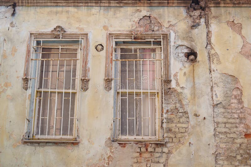 The Weathered Wall with Secured Windows Stands Out in an Urban Setting ...