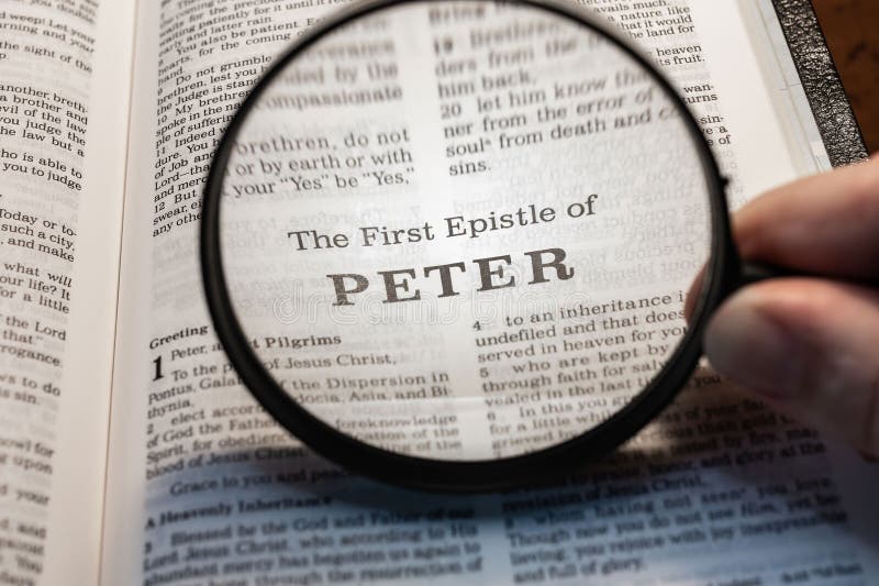 Closeup of a Person Holding a Magnifier and Reading the Book of Peter ...