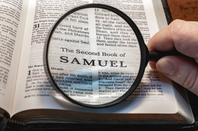 Closeup of a Person Holding a Magnifier and Reading the Book of Samuel ...