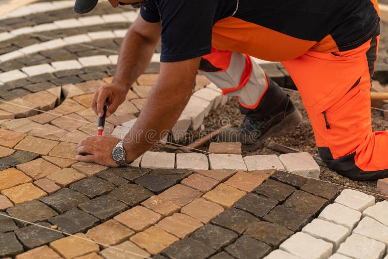 Closeup of a Person Laying Bricks and Taking Measurements in a ...