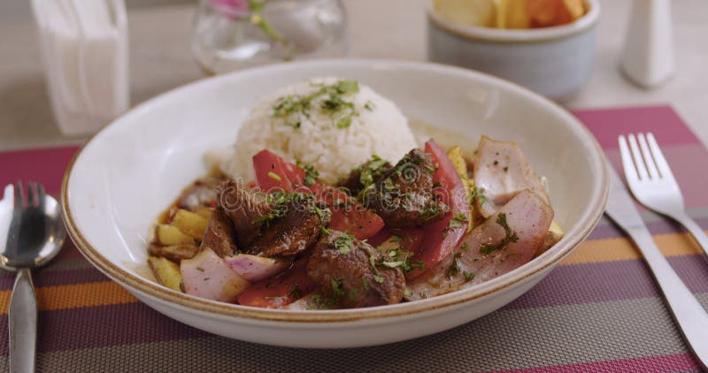 Closeup of Peruvian Sauteed Loin with Rice Served on a White Plate Over ...