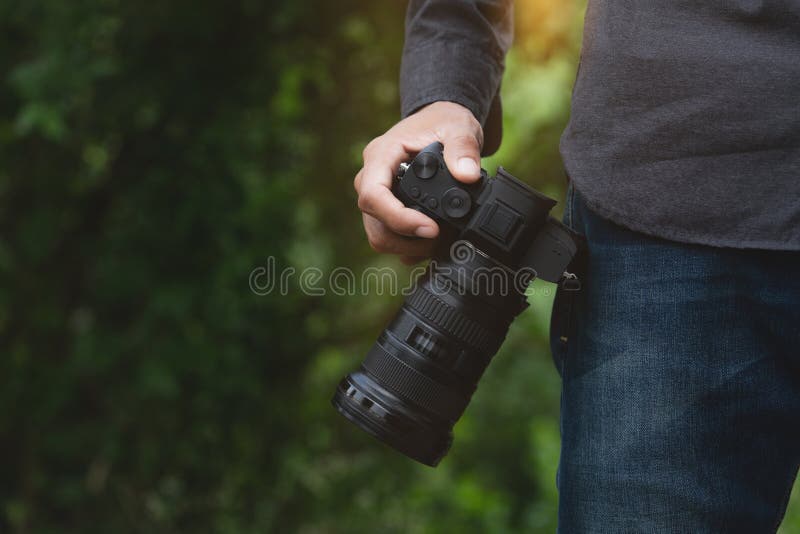 Closeup on Photographer Hand Holding Camera Stock Image - Image of ...