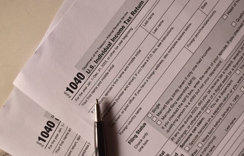 A Closeup Picture of a 1040 Forms on a Table with a Black Pen on it ...