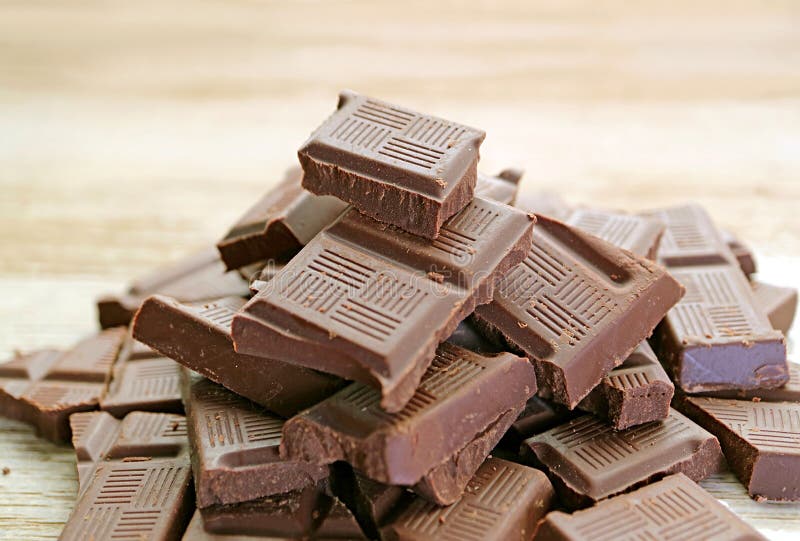 Pile of Dark Chocolate Chunks on Wooden Backdrop Stock Photo - Image of ...