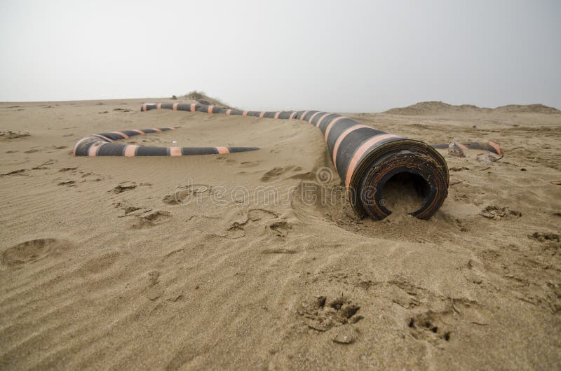 Closeup of a Pipe on the Sand in the Middle of the Beach Coast Stock ...