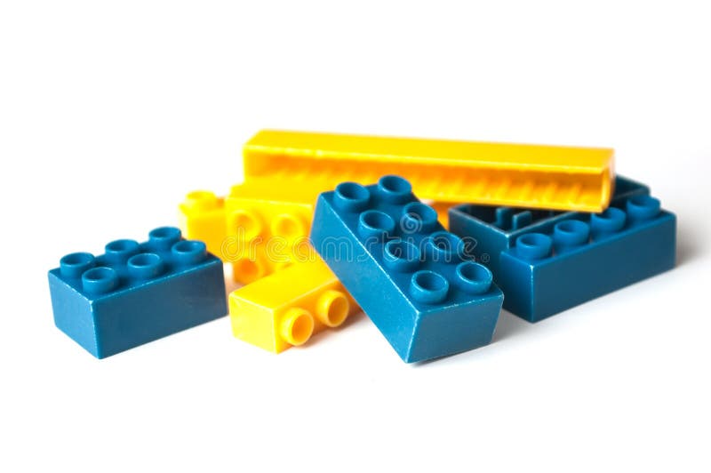 Red Plastic Bricks Construction on Yellow Background Stock Image ...