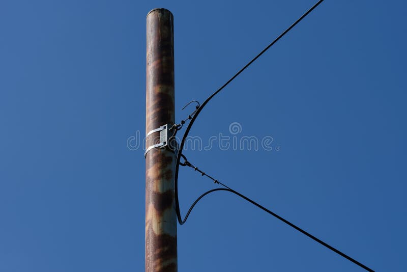 Closeup of a Pole with Optical Cable Fixed on it Against Blue Sky Stock ...