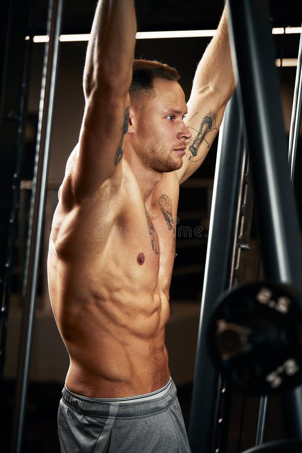 Closeup Portrait Of A Muscular Man Workout With Barbell At Gym Brutal