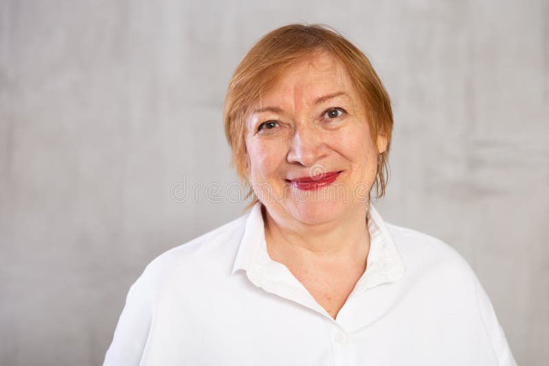 Closeup Portrait Of Smiling Older Woman In White Shirt Stock Image