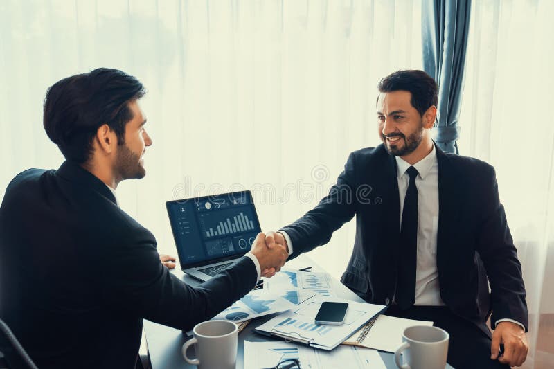 Closeup Businessman Handshake Over Desk with BI Papers. Fervent Stock ...