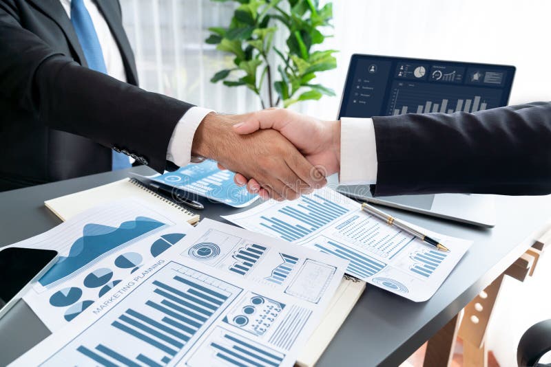 Closeup Businessman Handshake Over Desk with BI Papers. Fervent Stock ...