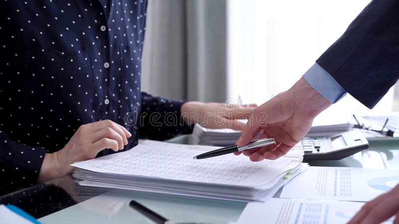 Closeup of Professionals Exchanging Business Documents in a Formal ...