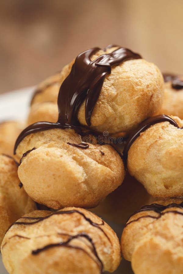 Closeup Profiteroles with Fine Dark Chocolate on Plate Stock Image ...