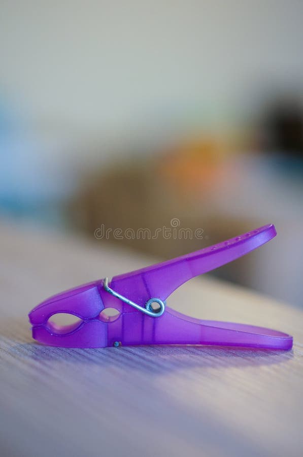 Top View Closeup of a Purple Plastic Clothespin Placed on a Wooden ...
