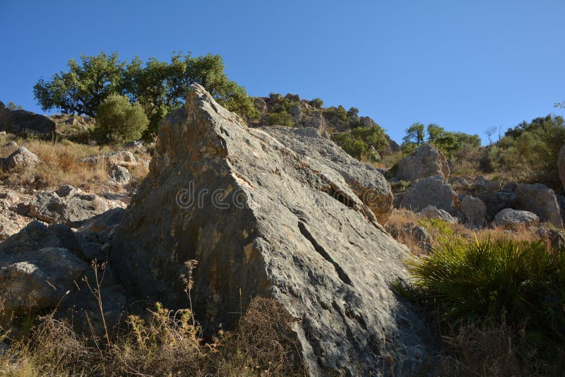 Closeup of a Pyramid Shaped Stone on a Rocky Slope of a Mountain Under ...