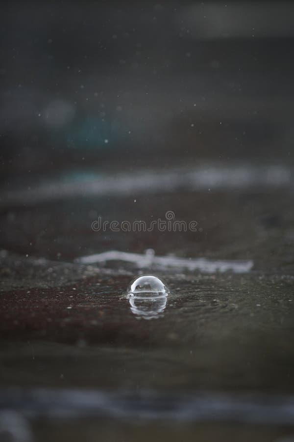 Rain Bubble in a Puddle on a Mat. Stock Image - Image of wiping ...