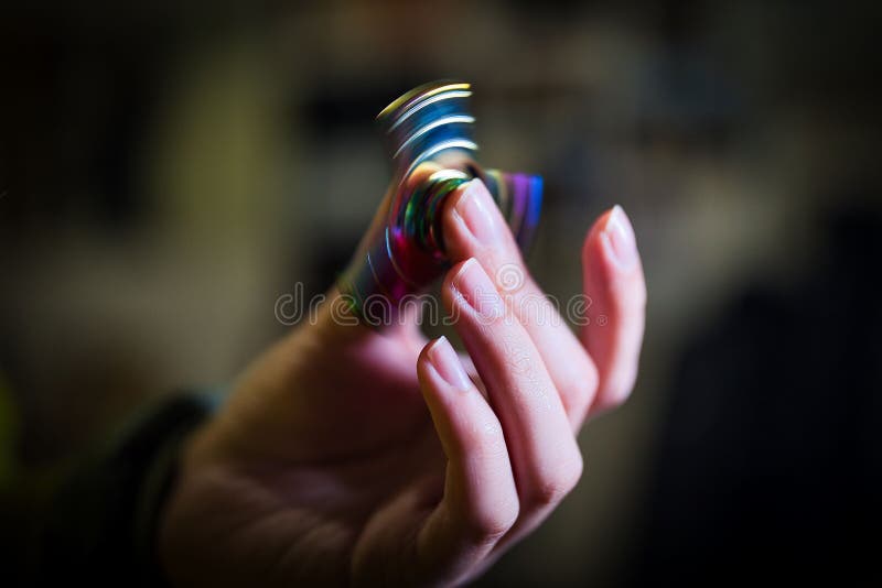 Closeup of a Rainbow Colored Fidget Spinner Rolling in Hand Stock Photo ...