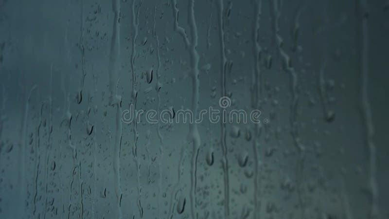 Closeup of Raindrops Falling Down a Glass Surface Stock Footage - Video ...