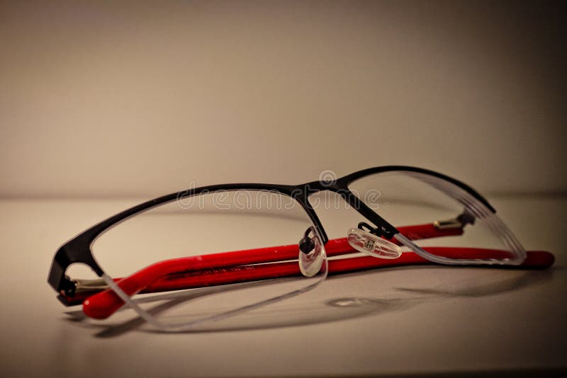Closeup of Red and Black Glasses Sitting on a Shelf Stock Photo - Image ...