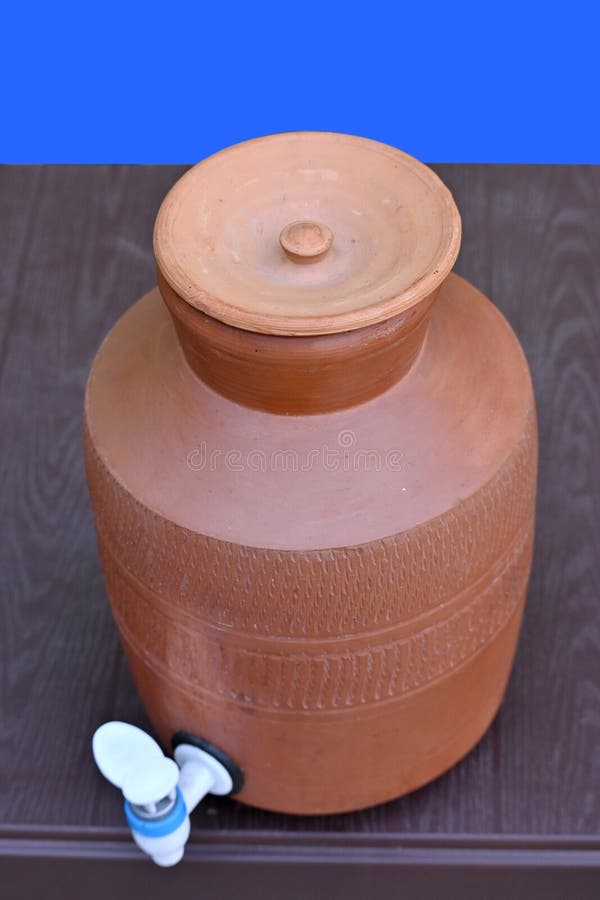Closeup the Red Brown Earthen Clay Filter with Blue White Tap on the ...