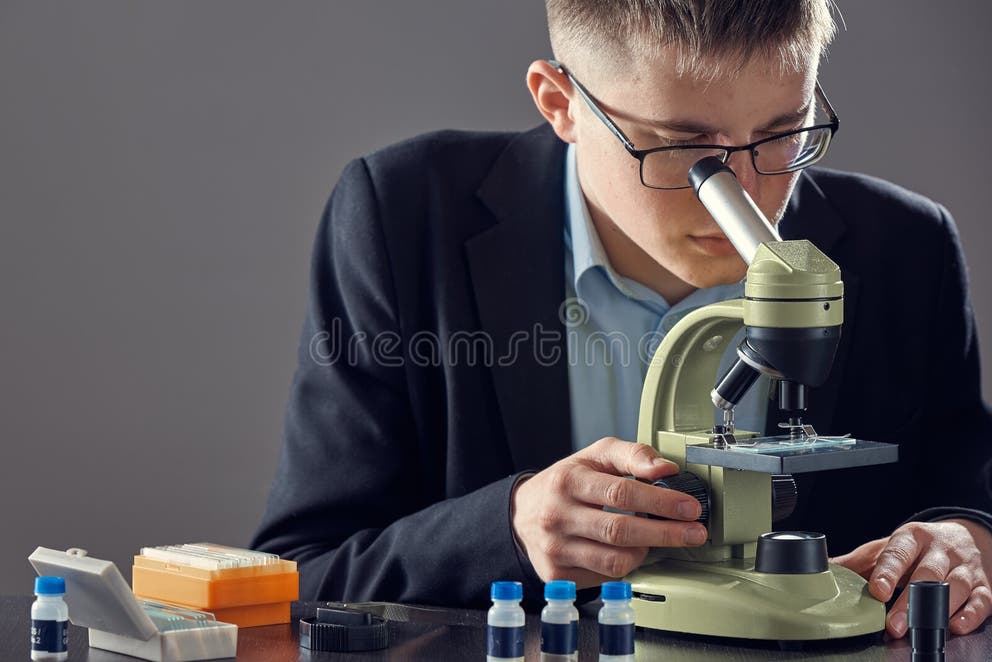 Closeup on Researcher Working with Microscope in Laboratory. a Guy with ...