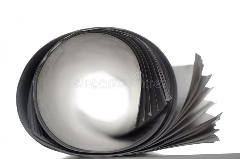 Closeup of a Rolled Paper Under the Lights Against a White Background ...