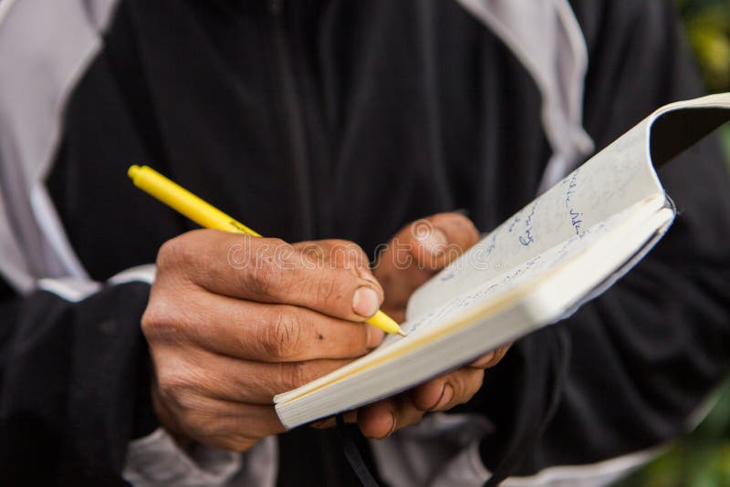 Closeup of Rough Hands Taking Notes with Yellow Pen Stock Image - Image ...