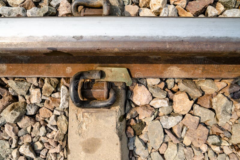 Closeup of Rusty Iron Train Track with Railroad Tie and Pebbles. Stock ...