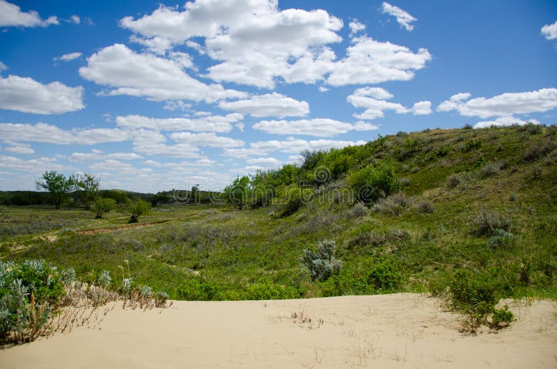 Closeup of a Sandy Area and Green Hill on a Sunny Day Stock Image ...