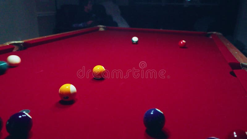 Closeup of Balls Game in Motion, Across a Red Pool Table with a Blurred ...