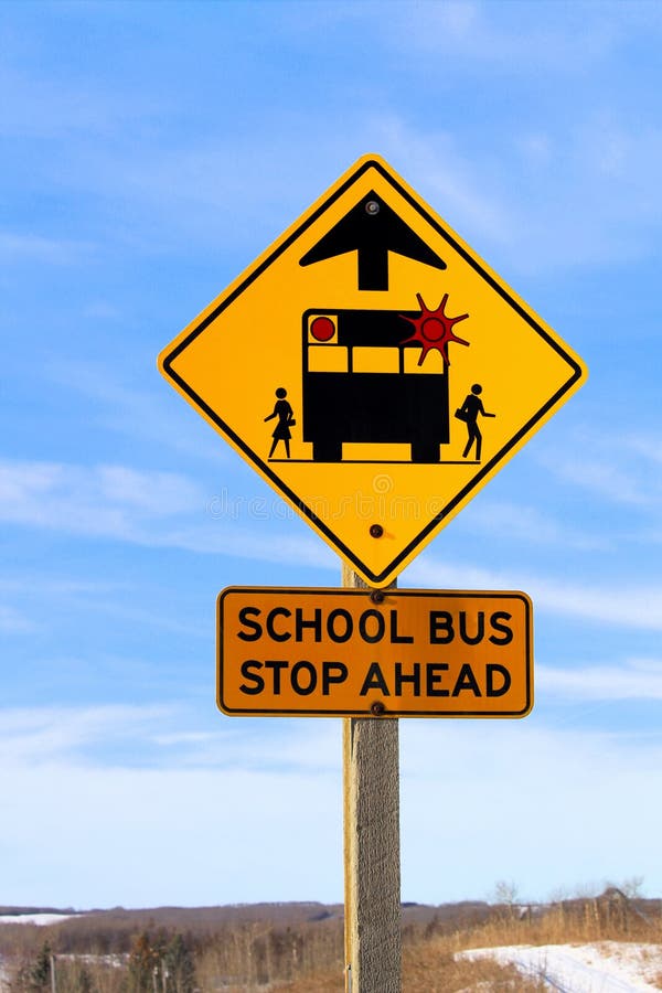 Closeup of a School Bus Stop Ahead Sign Against a Blue Sky Stock Image ...