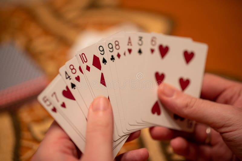 Closeup Selective Focus Shot of a Hand Holding a Hand of Playing Cards ...