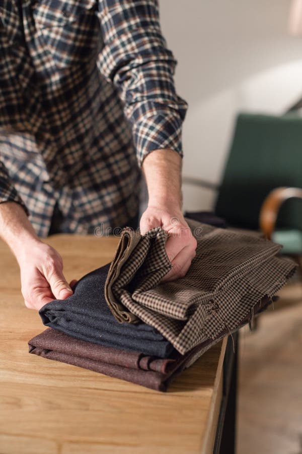 Closeup. Selects Wool from the Stack. Young Man Working As a Tailor and ...